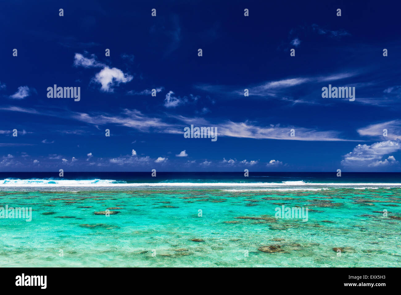 Blue sky and vibrant surf beach on a coral reef, tropical island Stock ...