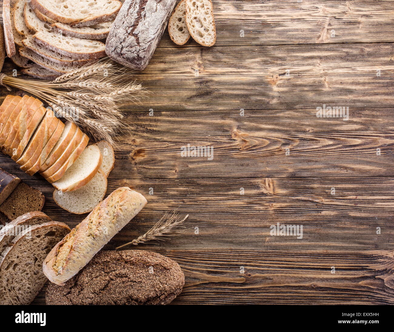 The bread and a wheat on the wooden desk Stock Photo - Alamy