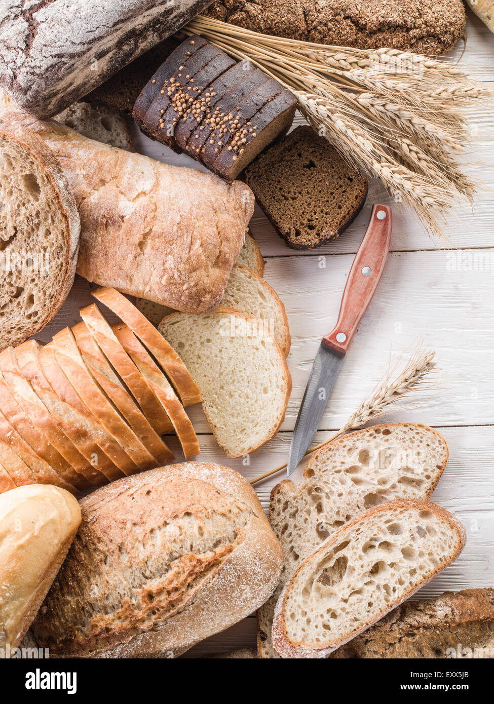 The bread and a wheat on the wooden desk Stock Photo - Alamy
