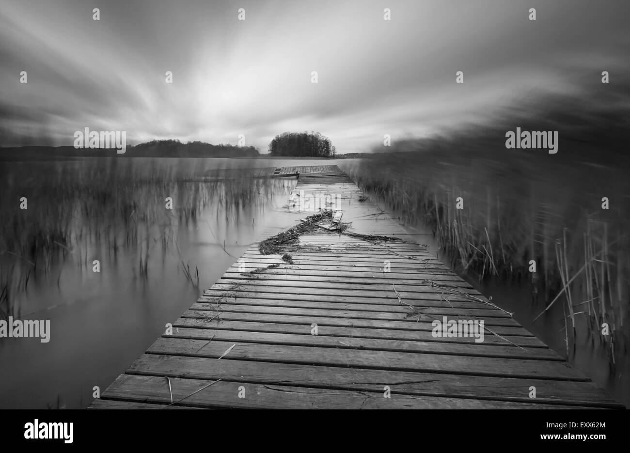 lake with jetty. long exposure landscape. Autumnal bad weather ...