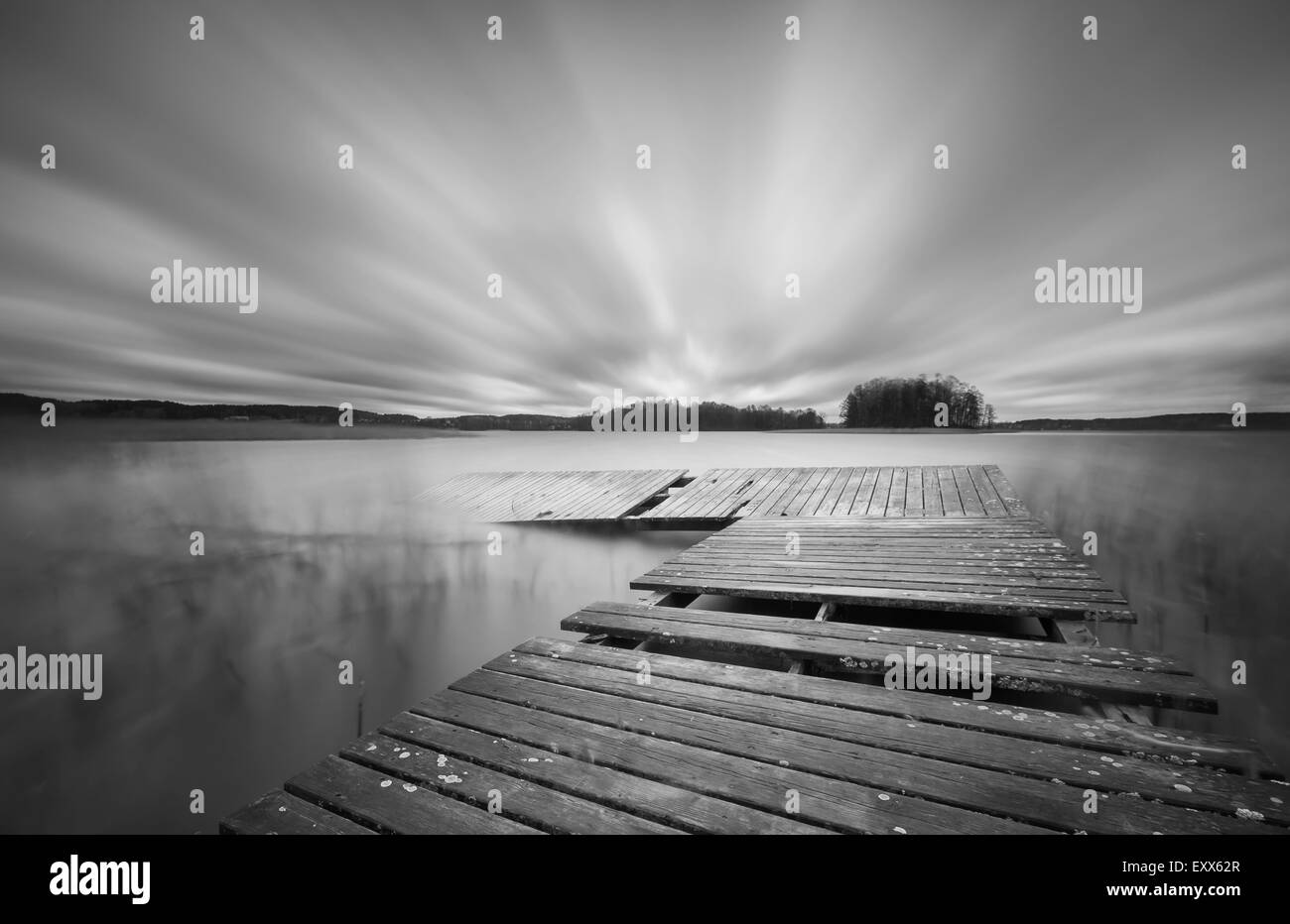 lake with jetty. long exposure landscape. Autumnal bad weather ...