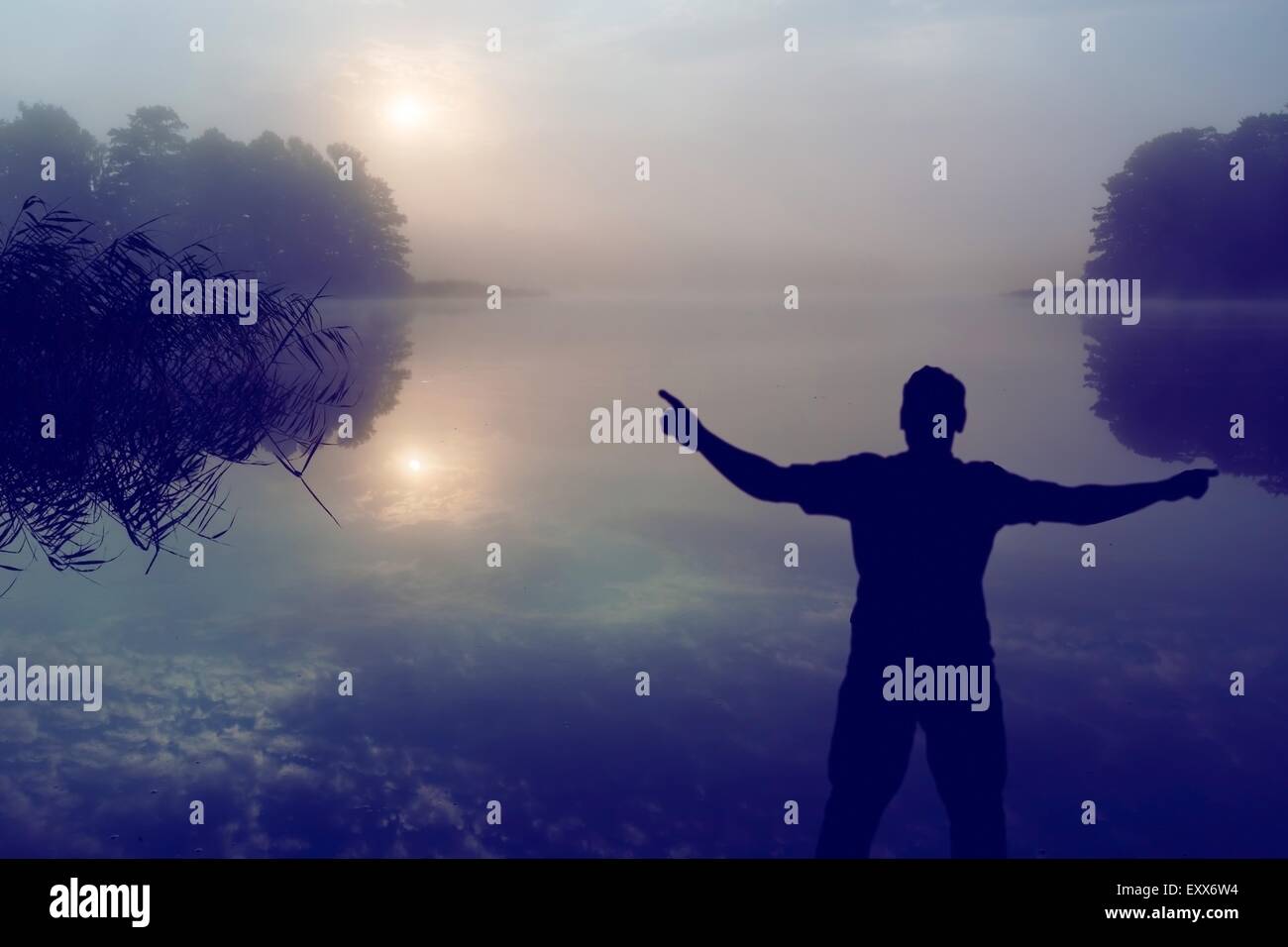 Man watching a sunrise over lake. Human silhouette. Photo with vintage ...