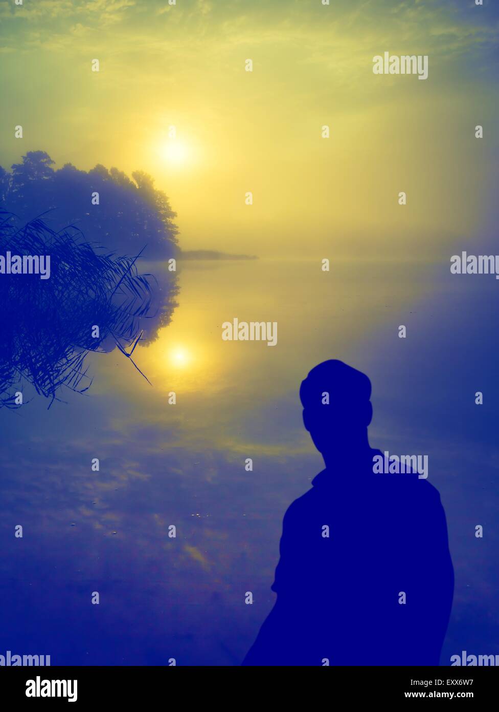 Man watching a sunrise over lake. Human silhouette. Photo with vintage ...