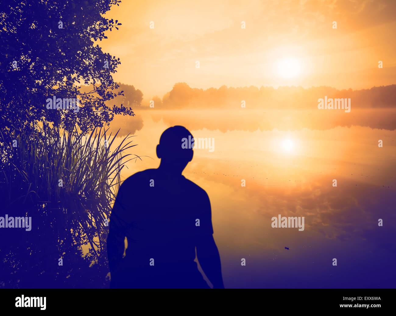 Man watching a sunrise over lake. Human silhouette. Photo with vintage ...