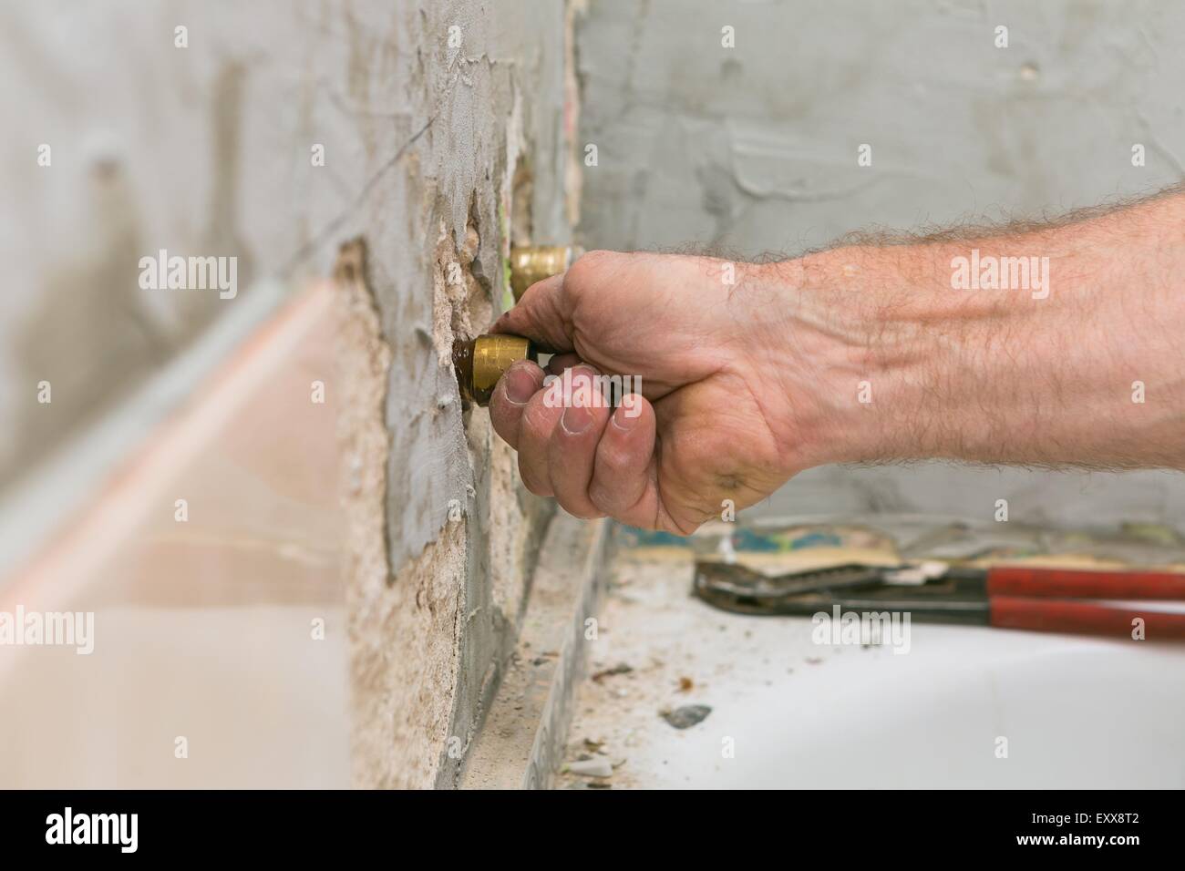 Plumber working with water installation, only hands Stock Photo - Alamy