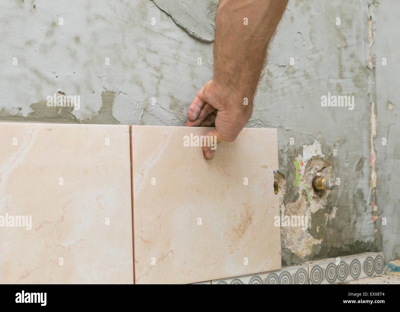 construction mason man hands on tiles work with cement mortar Stock ...