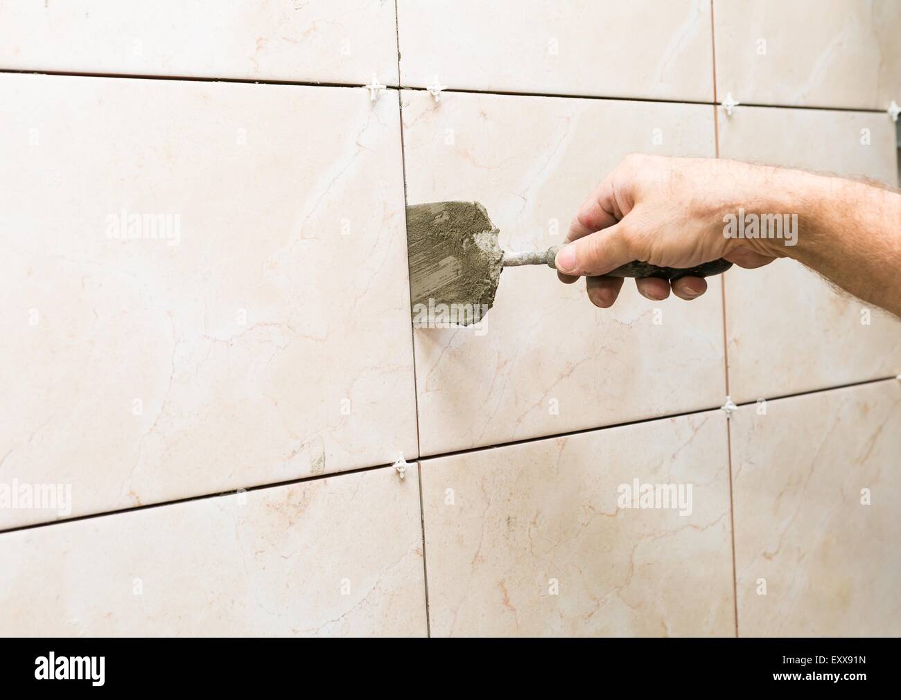construction mason man hands on tiles work with cement mortar Stock ...