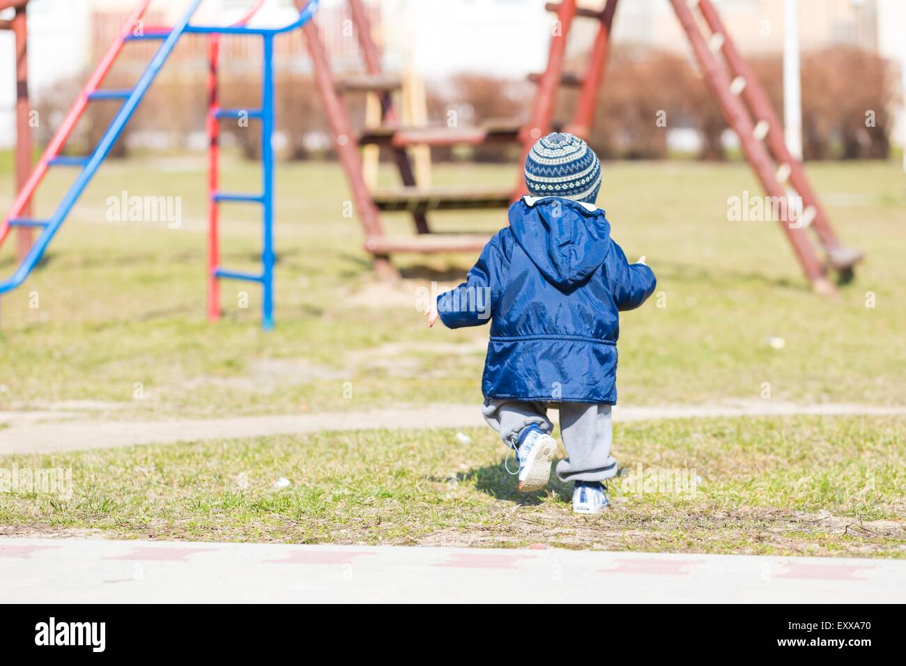 Toddler child photographed from behind walking outside Stock Photo - Alamy