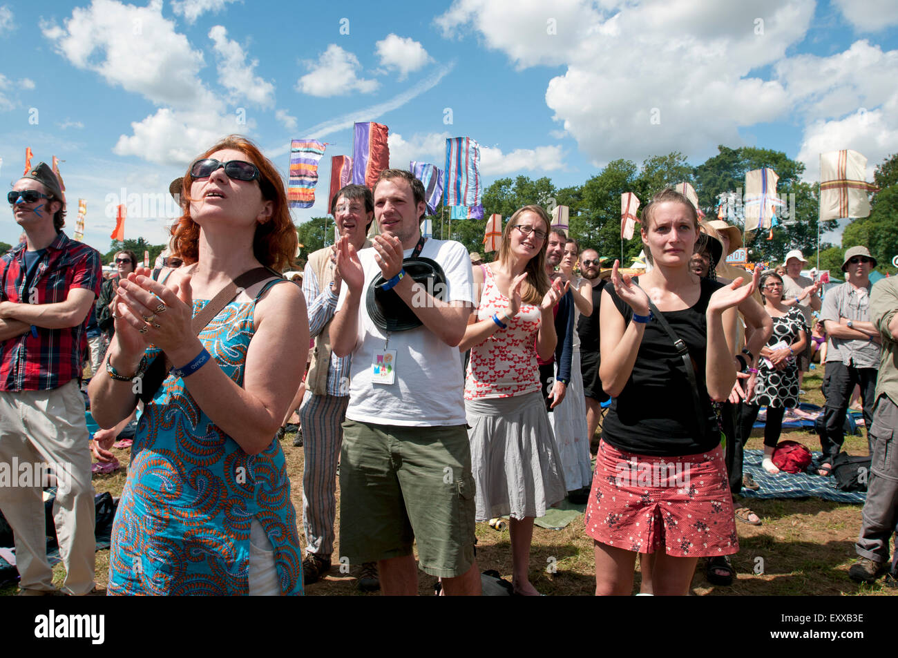 Crowds of festival goers applauding and looking at the stage at the ...