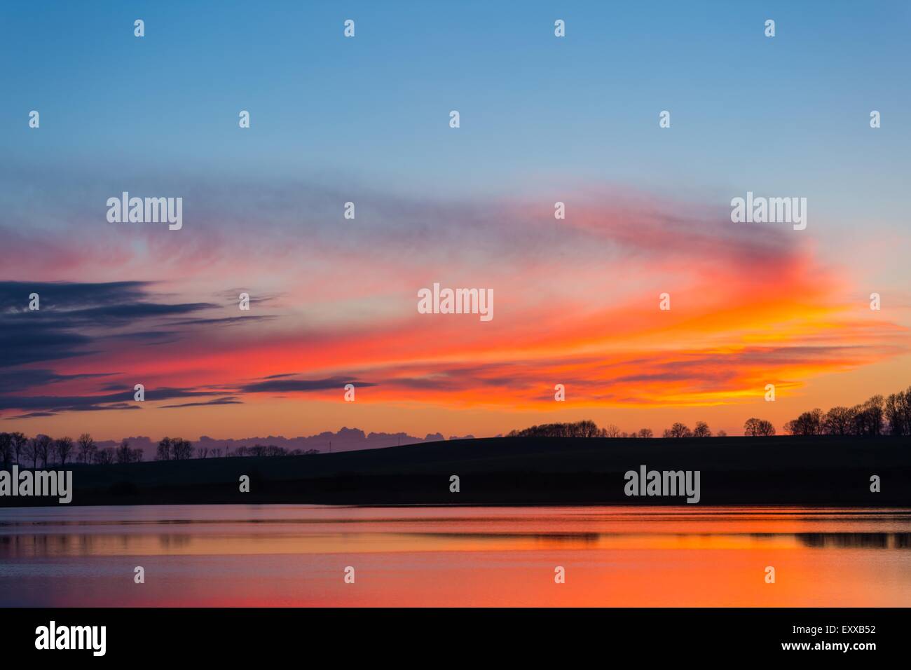 Beautiful sunset over calm lake. Colorful and vibrant landscape of lake ...
