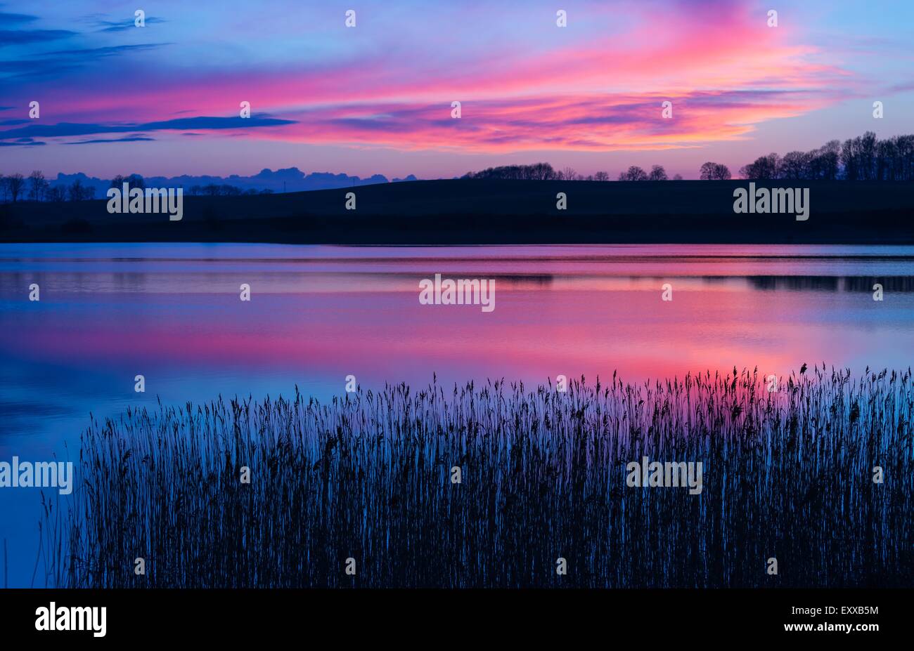 Beautiful sunset over calm lake. Colorful and vibrant landscape of lake ...