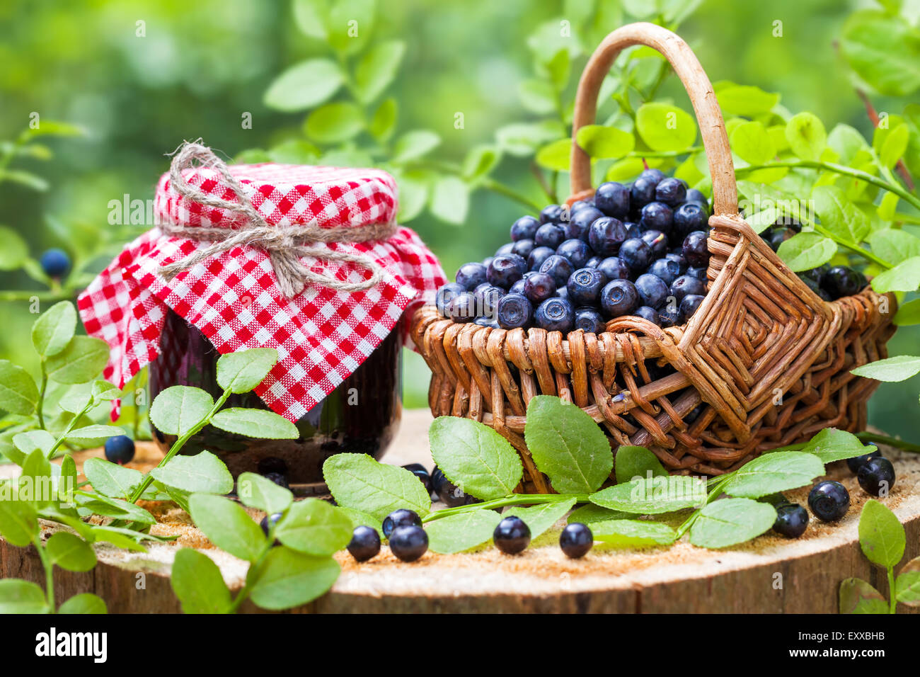Jars of jam and basket with wild blueberries Stock Photo - Alamy