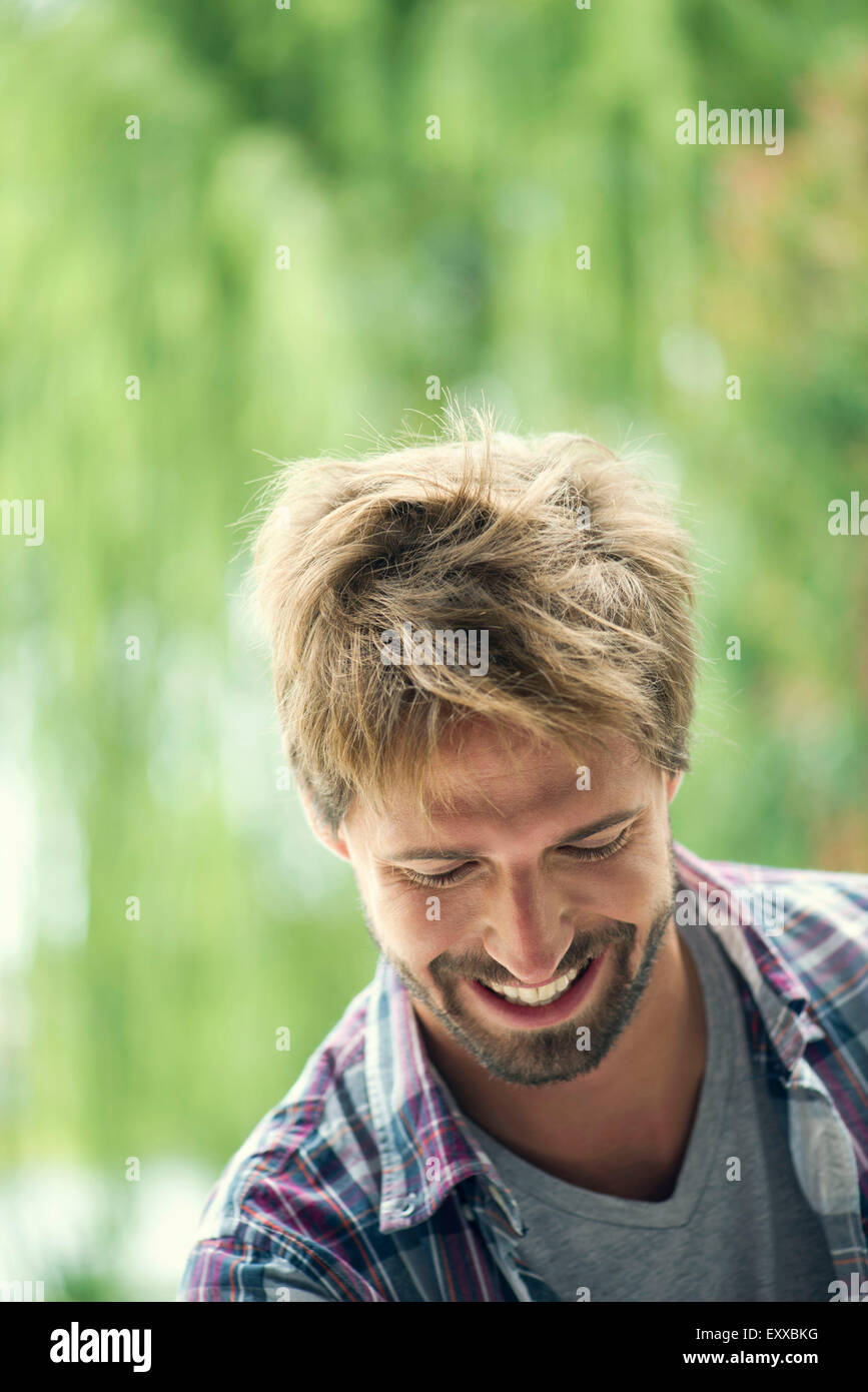 Man looking down and smiling, portrait Stock Photo - Alamy