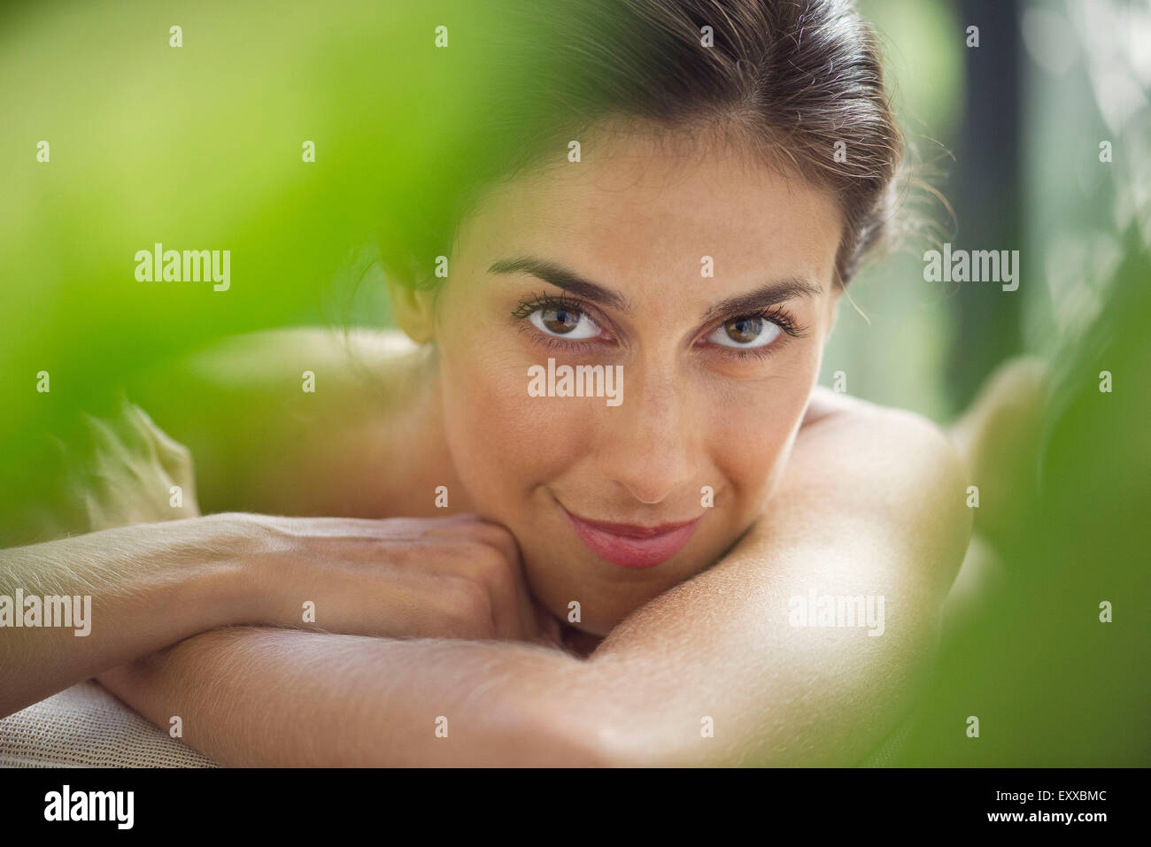 Woman resting head on arms Stock Photo - Alamy