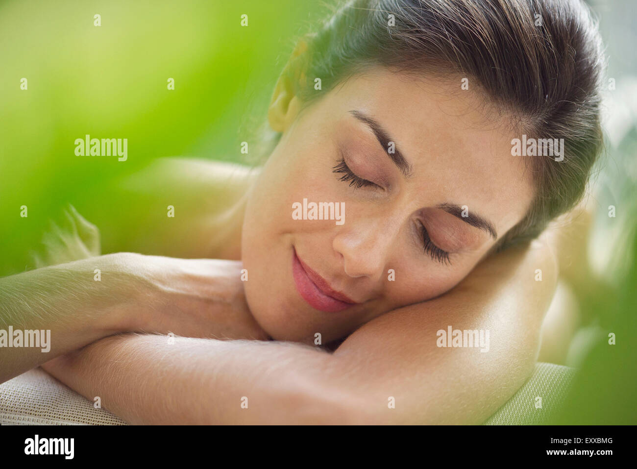 Woman resting head on arms Stock Photo - Alamy