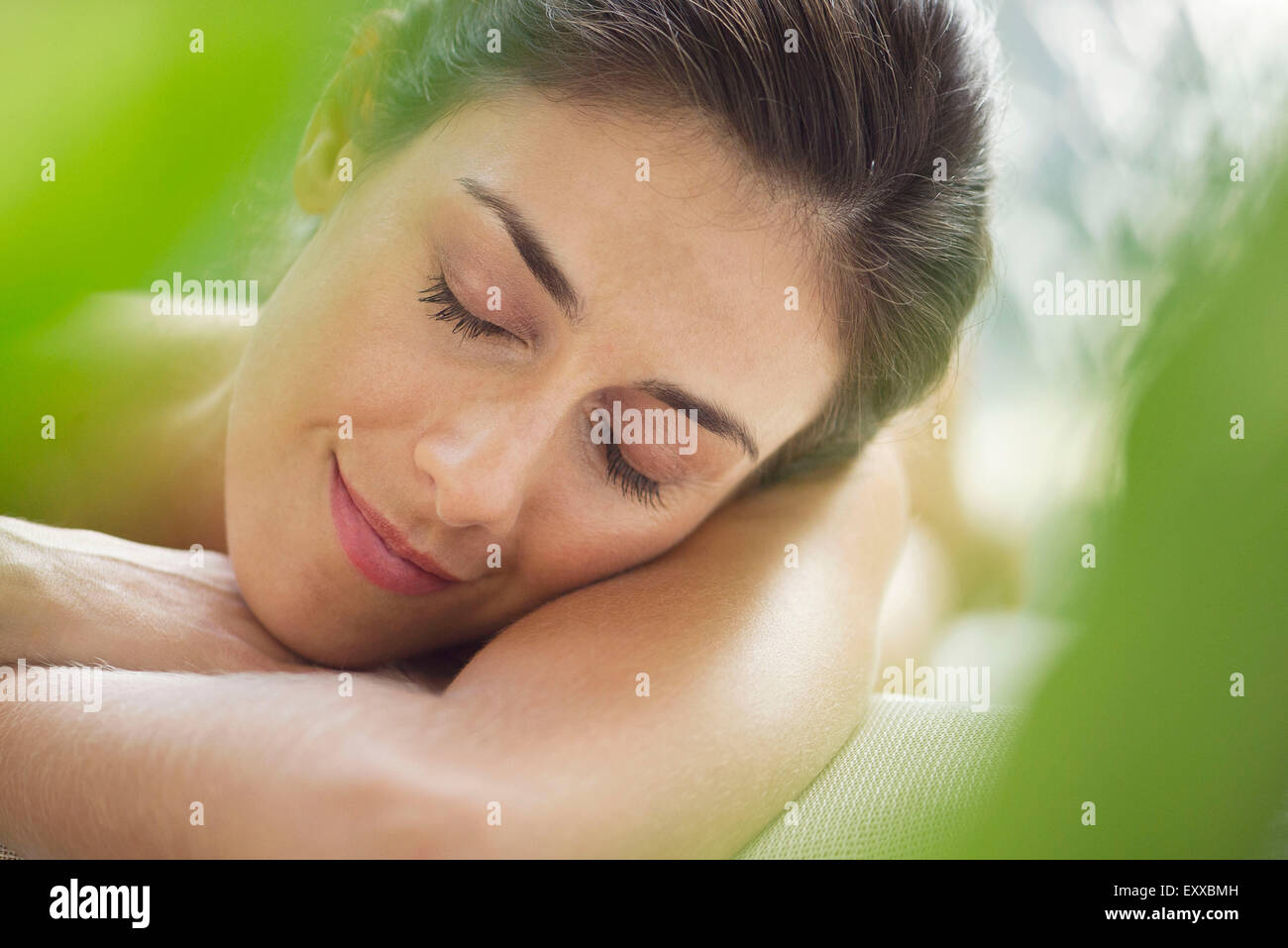 Woman resting head on arms Stock Photo - Alamy