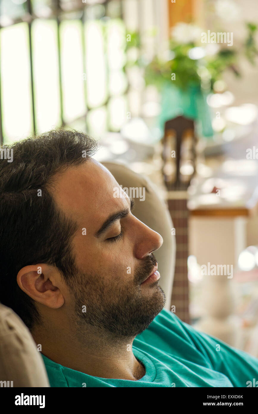 Man napping in armchair Stock Photo - Alamy