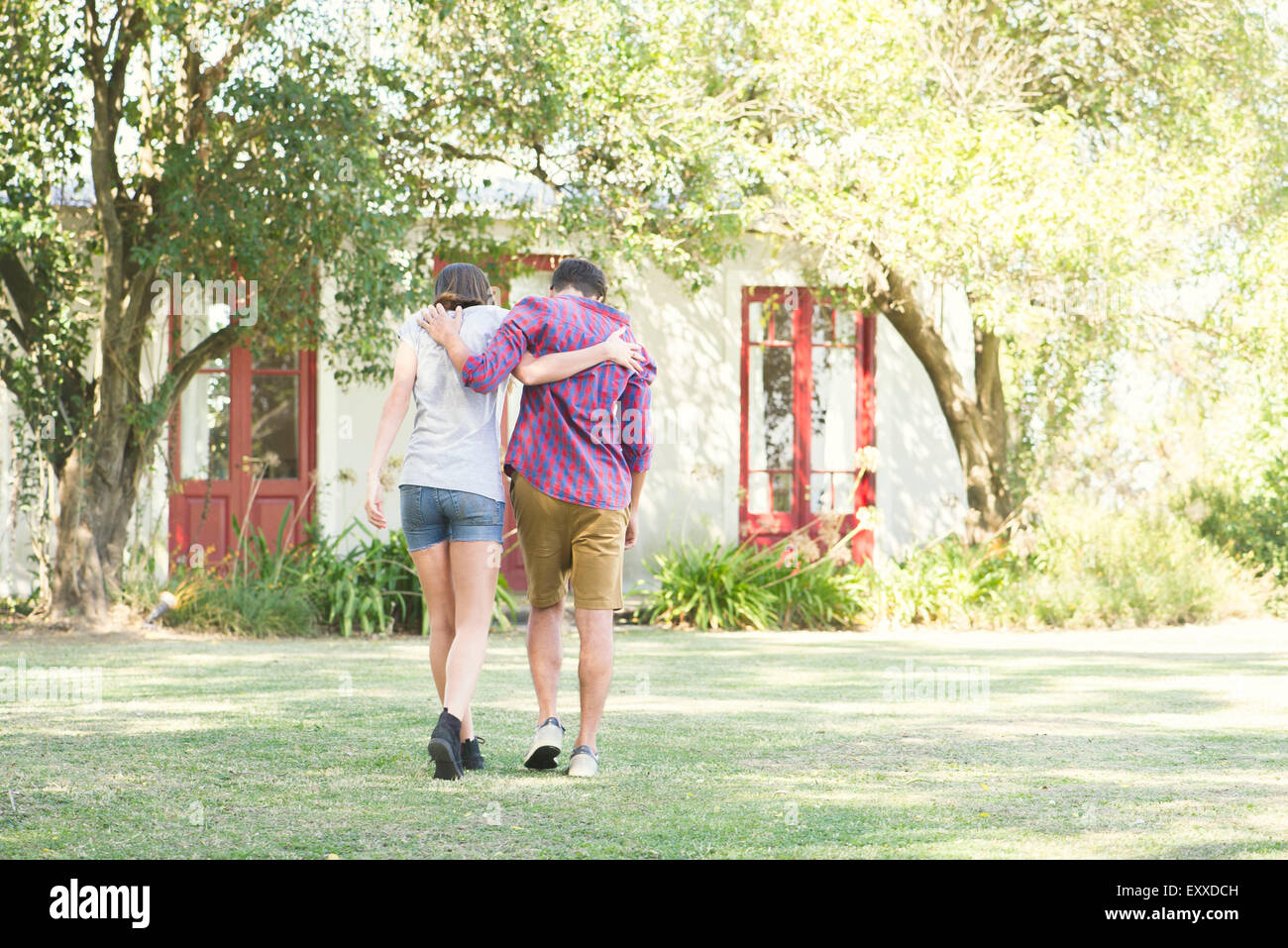 Couple arm shoulder walking hi-res stock photography and images - Alamy