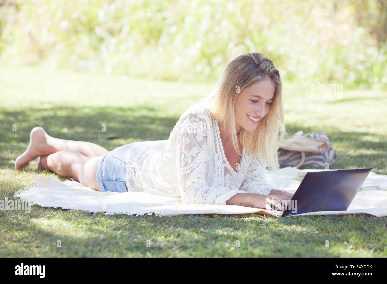 Woman using laptop outdoors Stock Photo - Alamy