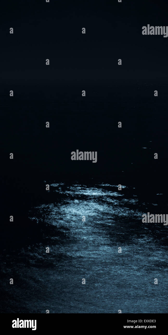 Moonlight reflected on ocean at night Stock Photo - Alamy