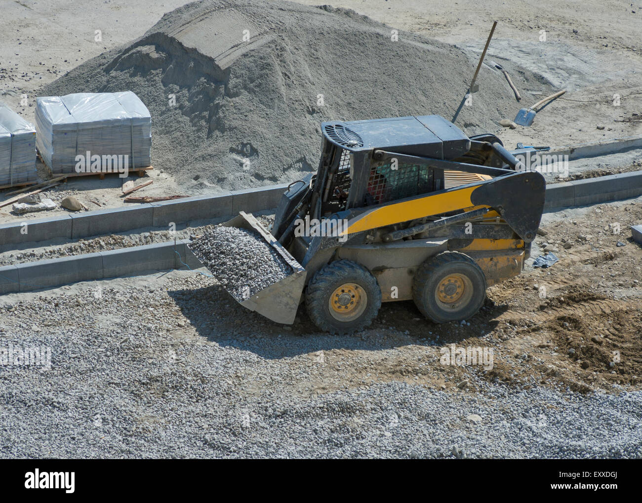 loader small bulldozer moving breakstone at construction area. view ...
