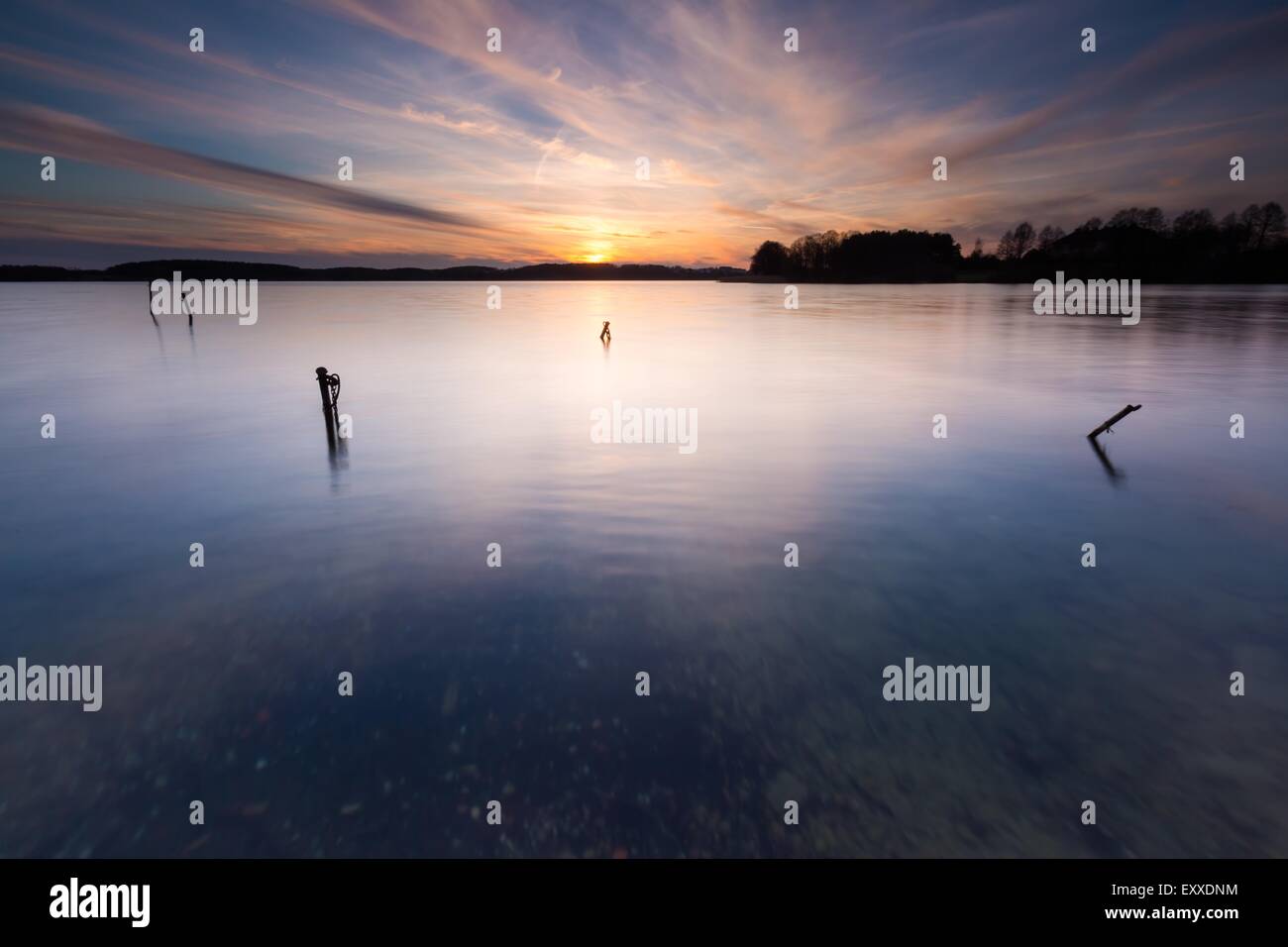 Beautiful sunset over calm lake in Mazury lake district. After sunset ...