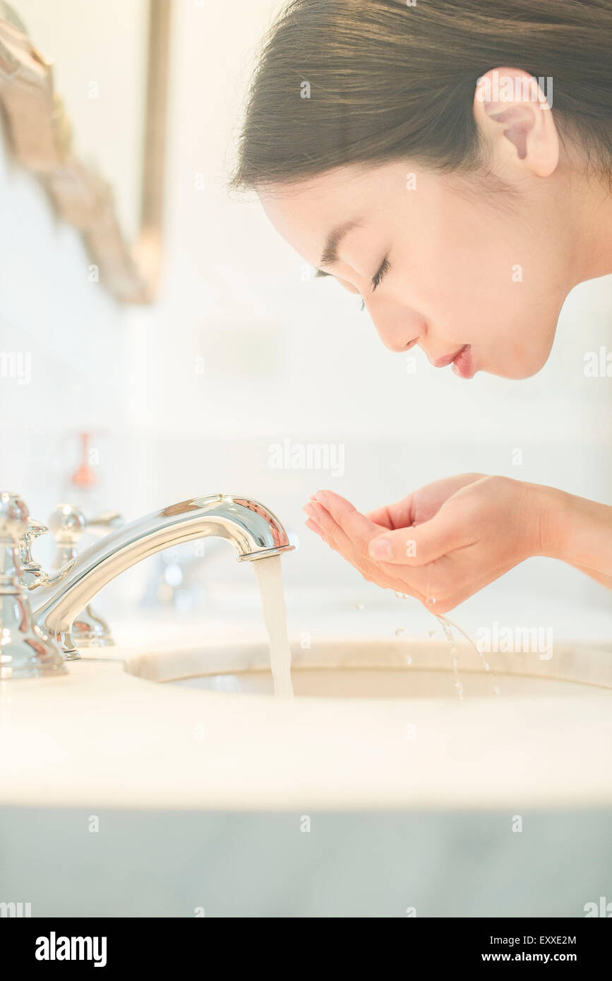Woman washing face Stock Photo - Alamy
