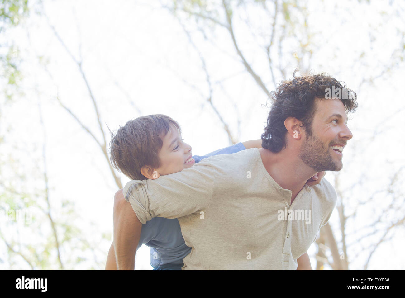 Father carrying young son piggyback Stock Photo - Alamy
