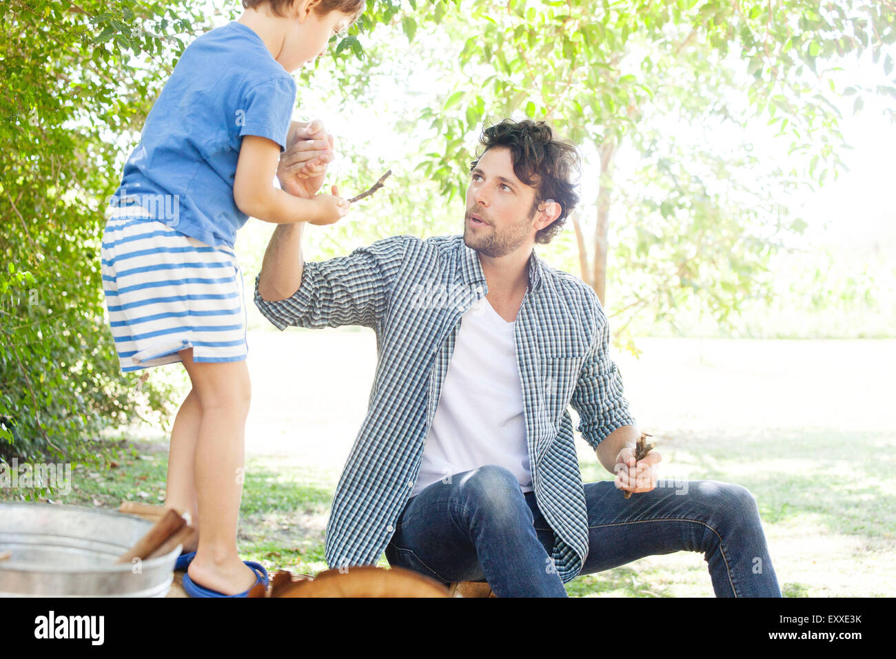 Father giving son helping hand Stock Photo - Alamy