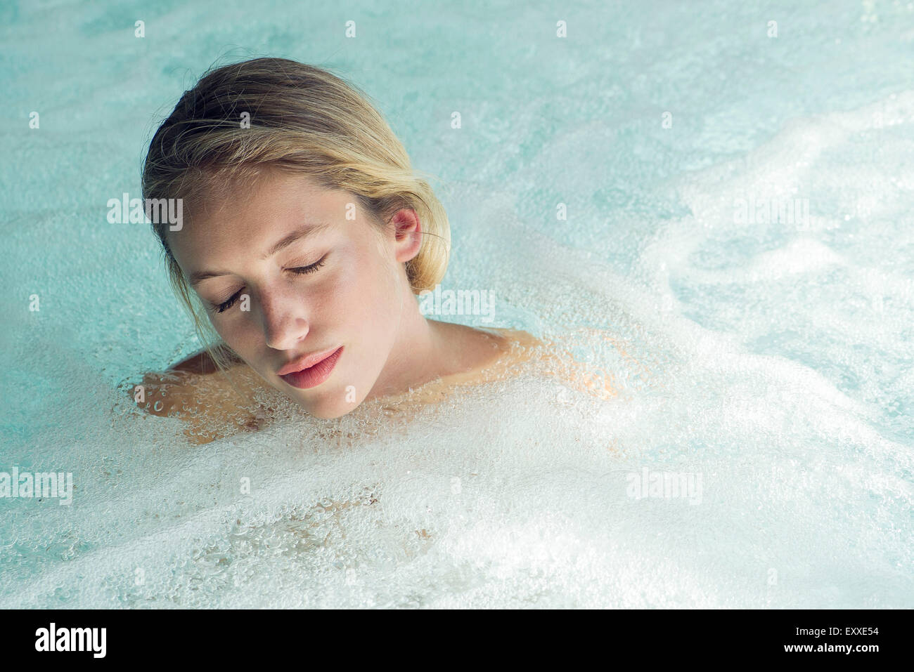 Woman soaking in spa pool Stock Photo - Alamy