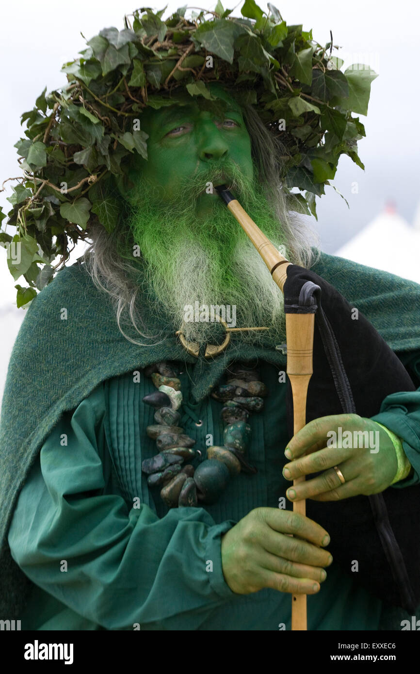 The green man playing a the pipes Stock Photo - Alamy