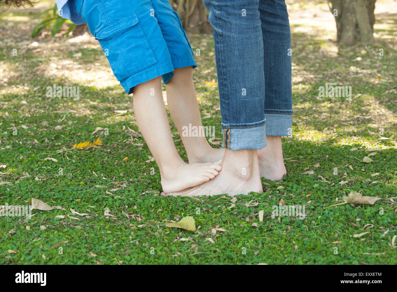 Little boy standing barefoot on father's feet, cropped Stock Photo - Alamy
