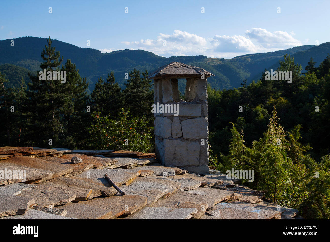 Vintage old stone authentic chimney on top of unique stone roof Stock ...
