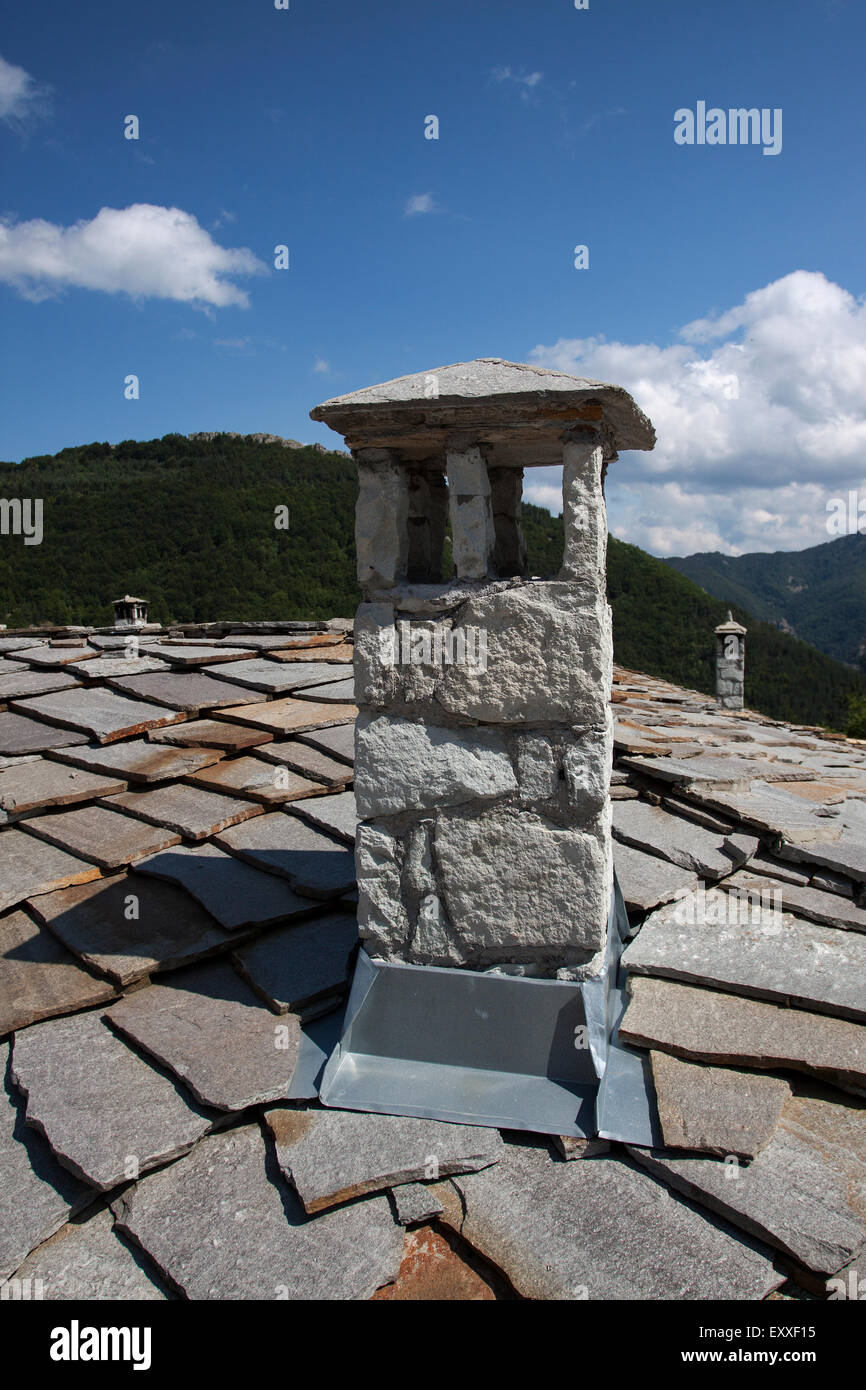Vintage old stone authentic chimney on top of unique stone roof Stock ...