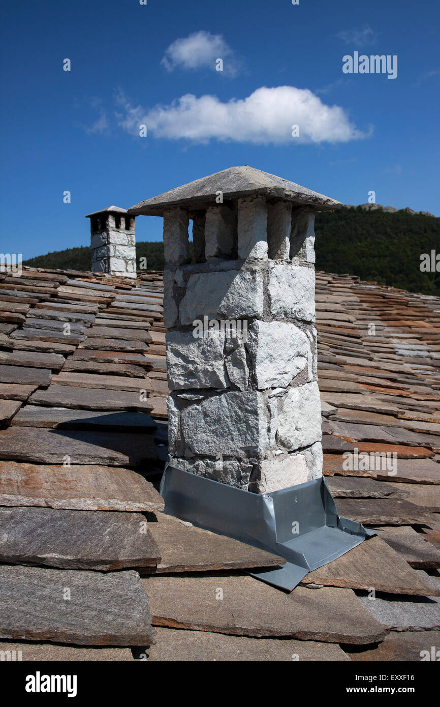Vintage old stone authentic chimney on top of unique stone roof Stock ...