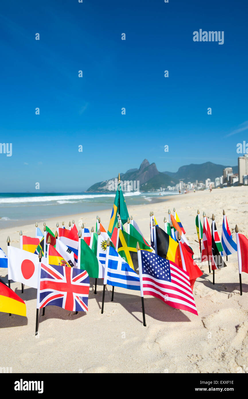 International flags fly with Brazilian flag on the sand against a ...