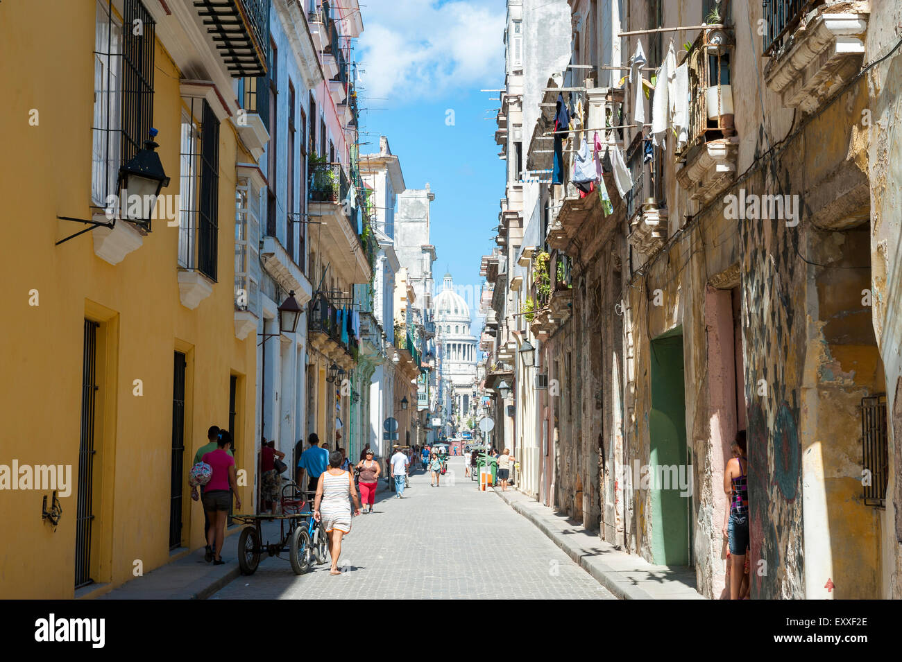 HAVANA, CUBA - CIRCA JUNE, 2011: Cubans walk on the shady side of a ...