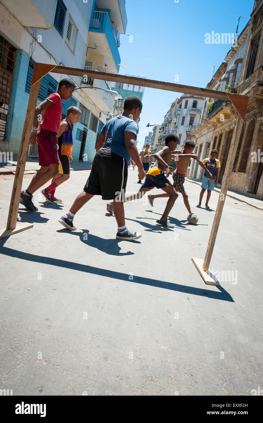 HAVANA, CUBA - JUNE 13, 2011: Young Cubans play a game of soccer on the ...