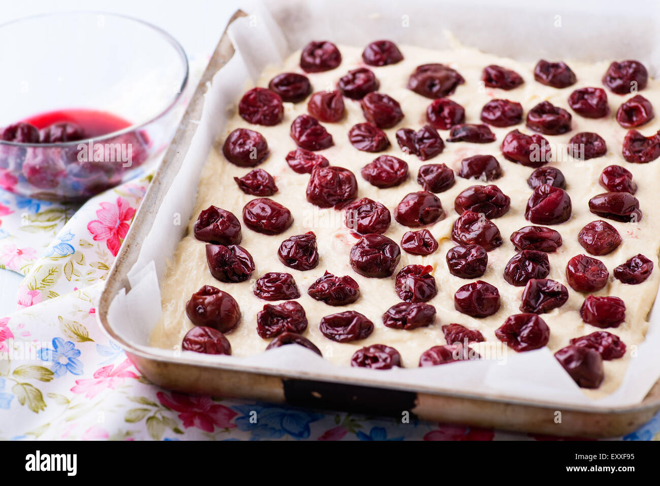 Raw homemade cherry cake in baking tray ready for oven, top view Stock ...