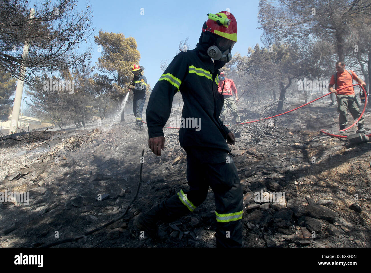 Athens, Greece. 17th July, 2015. Greek firemen try to extinguish flames ...