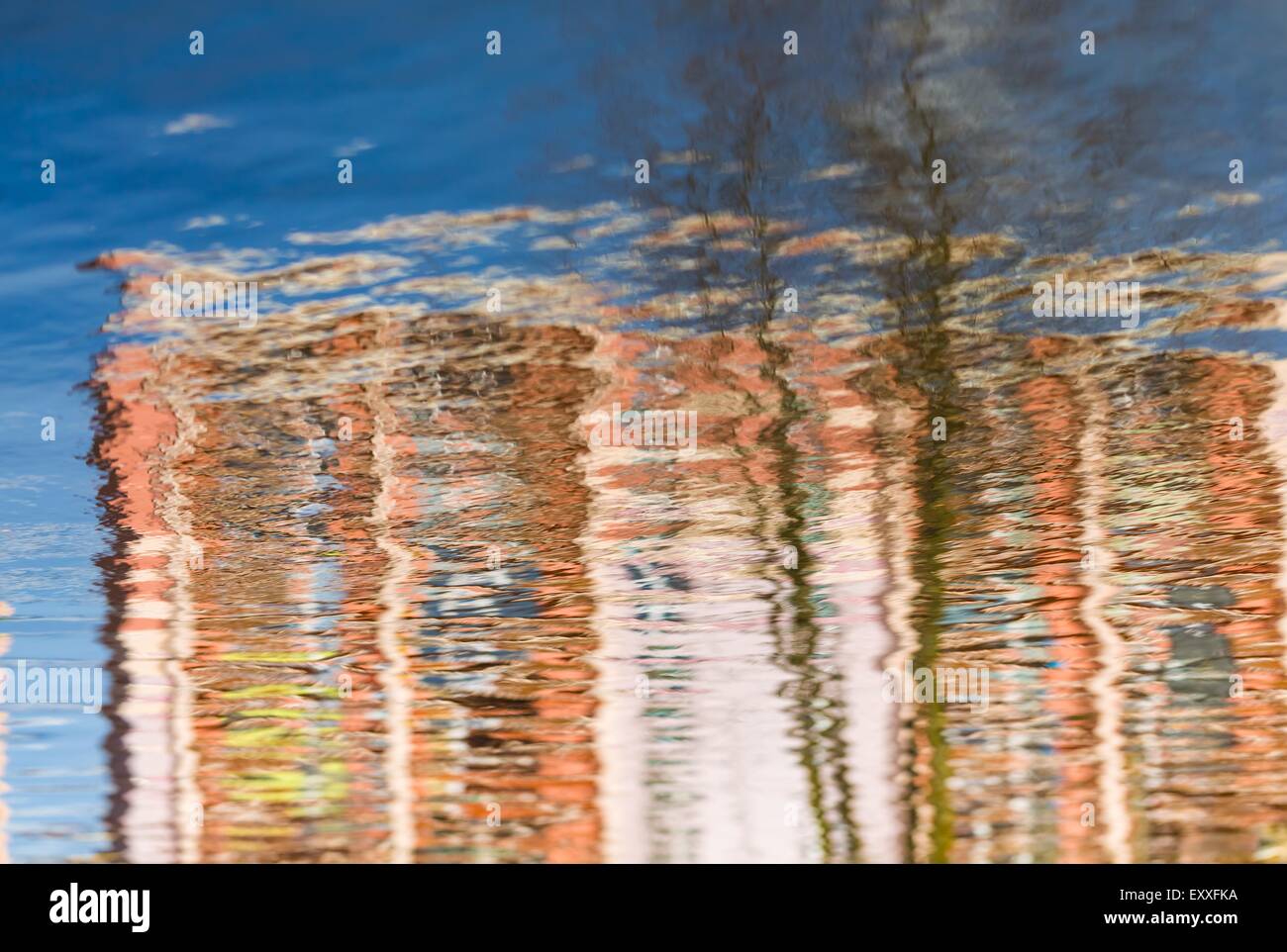close up of water surface with ripples. sky with clouds, building or ...