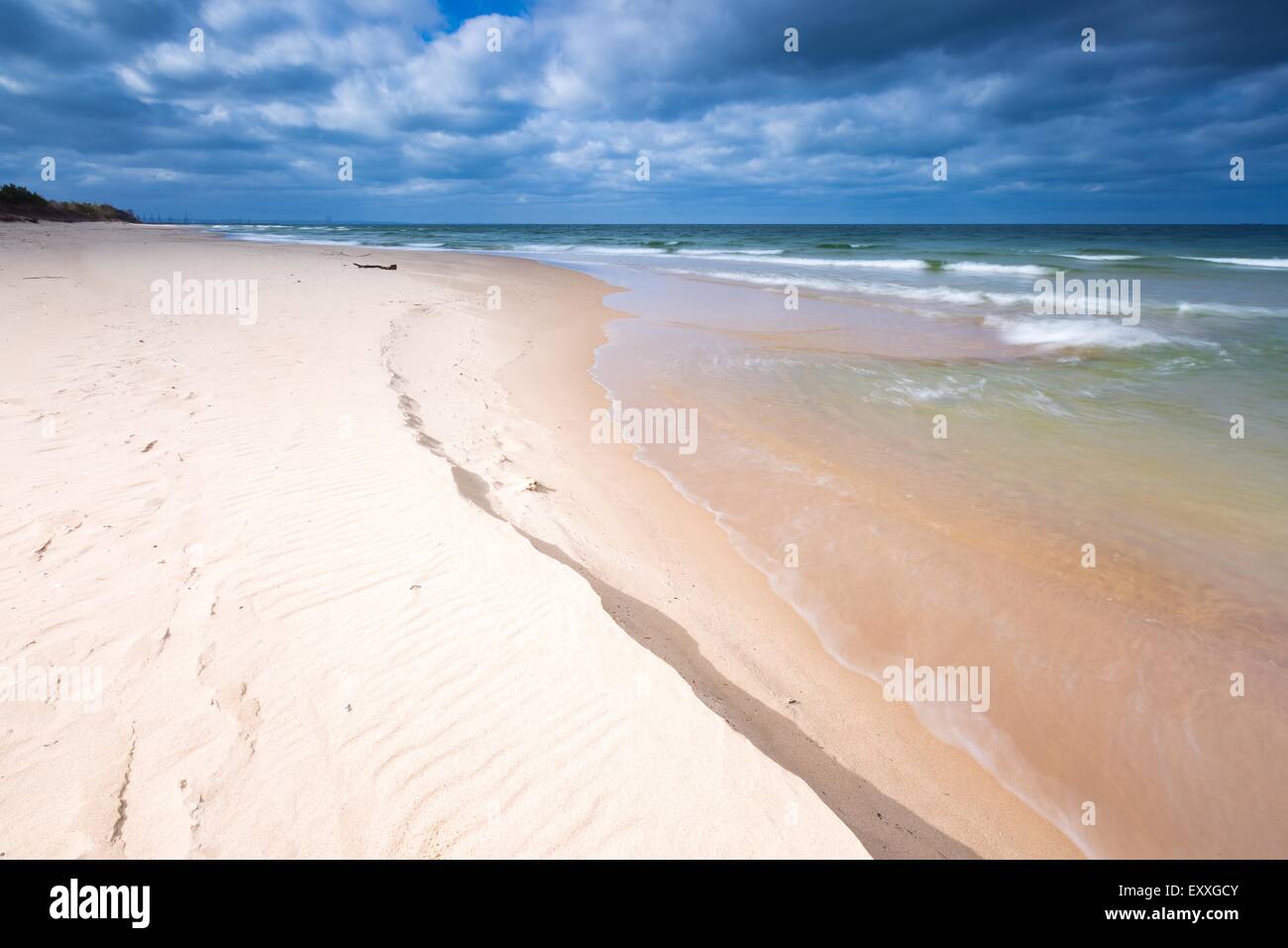 Beautiful beach landscape with cloudy sky and sea with waves. Baltic ...