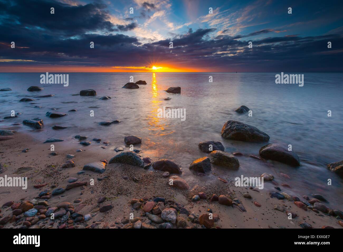 Beautifu rocky sea shore at sunrise or sunset. Long exposure landscape ...