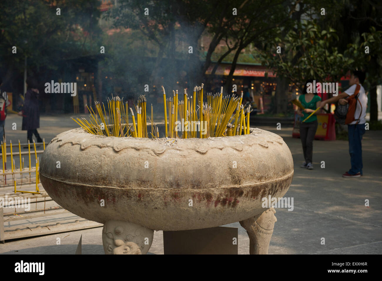 Buddhist ritual of Incense offerings placed in a censer at the entrance ...