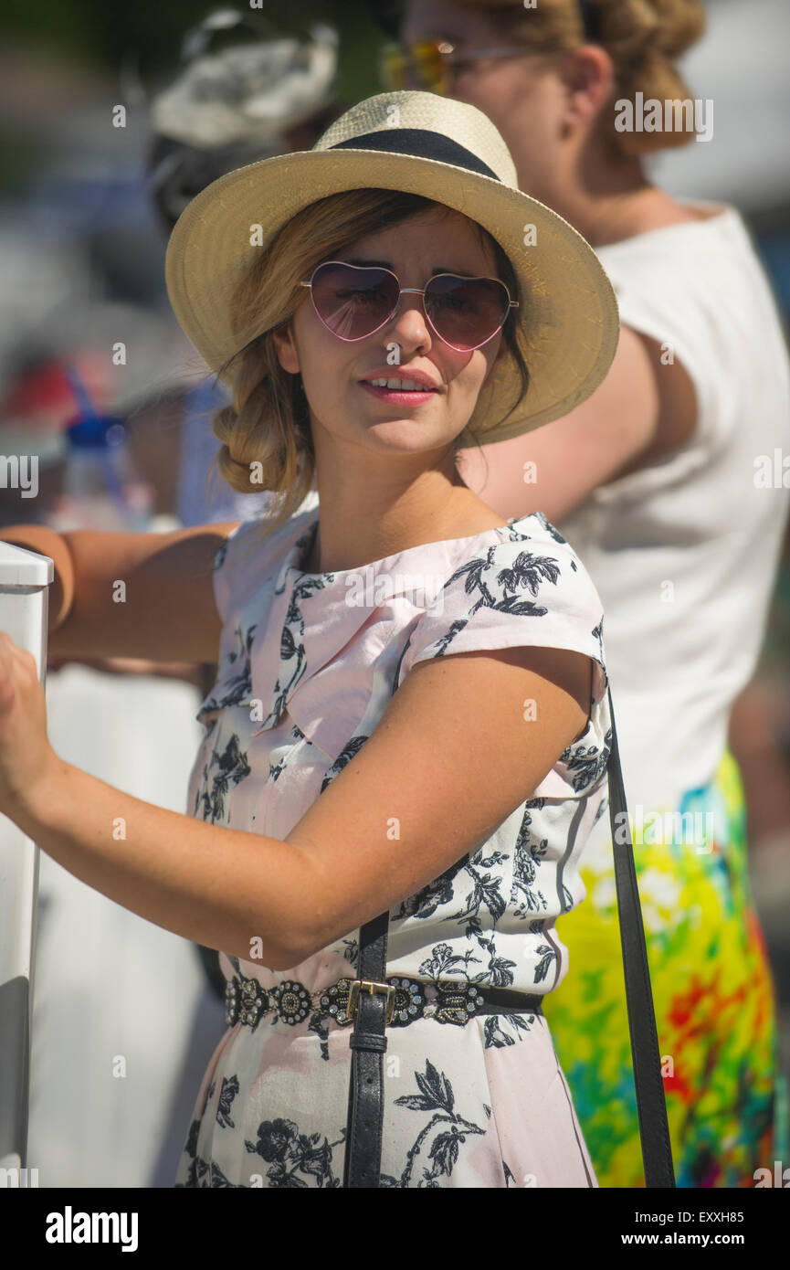 Female spectator in summer dress hat and sunglasses Stock Photo - Alamy