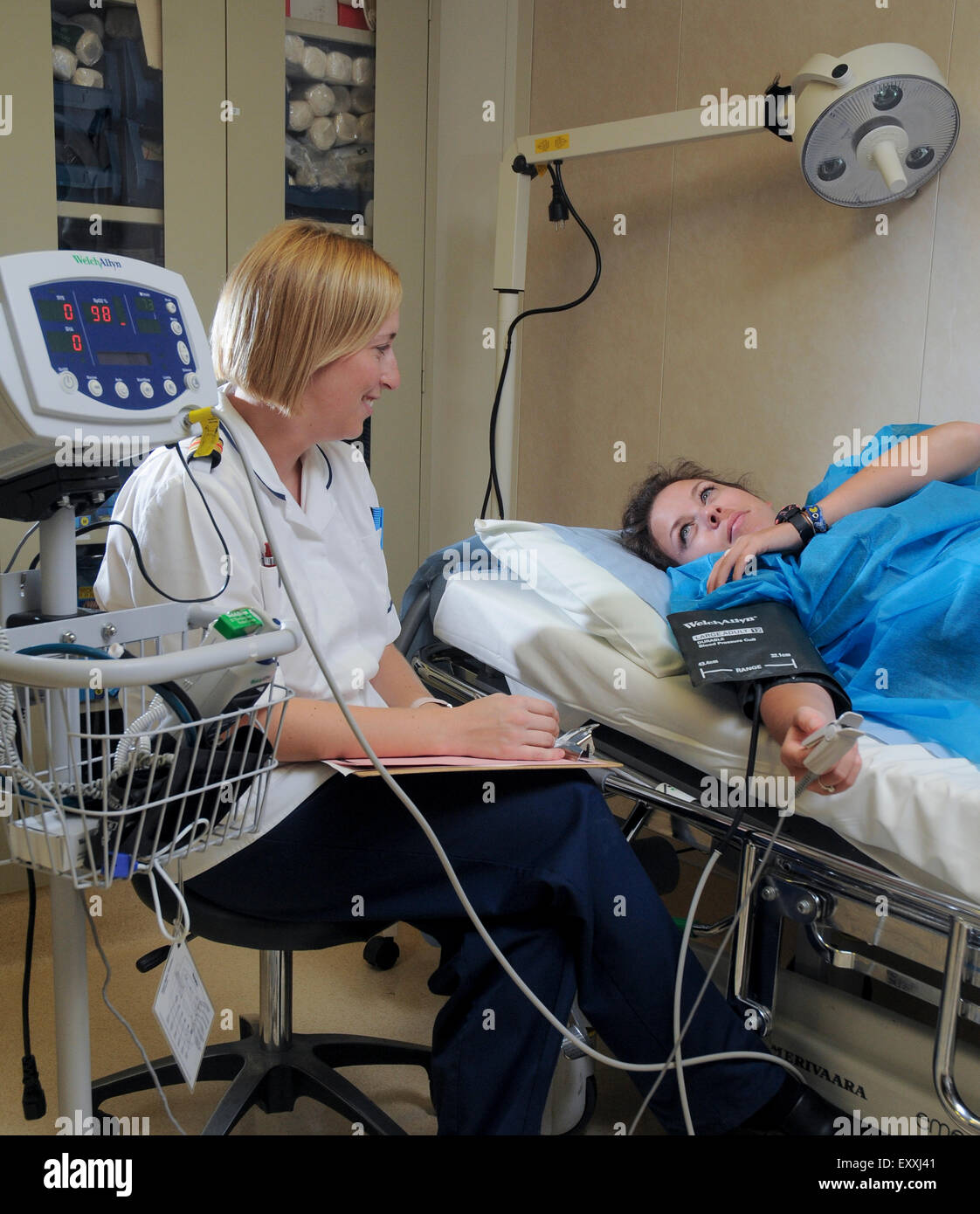 A patient is examined by a nurse in a medical bay. Credit: Euan Cherry ...