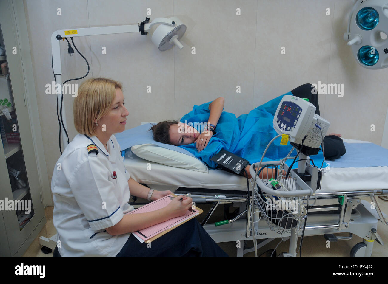 A patient is examined by a nurse in a medical bay. Credit: Euan Cherry ...