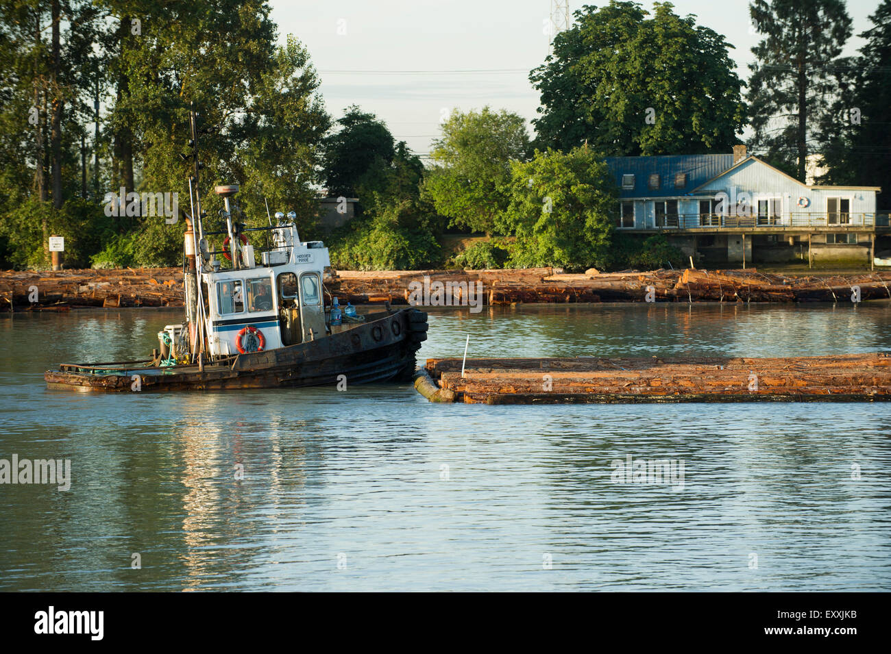 Tug Boat pushing log boom down the Fraser River, bordering Vancouver ...