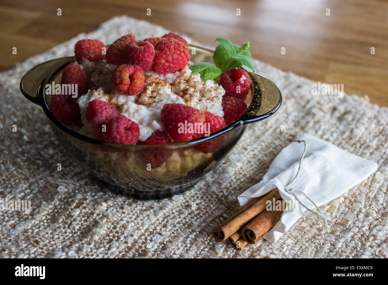 Rice pudding with raspberries and cinnamon Stock Photo - Alamy