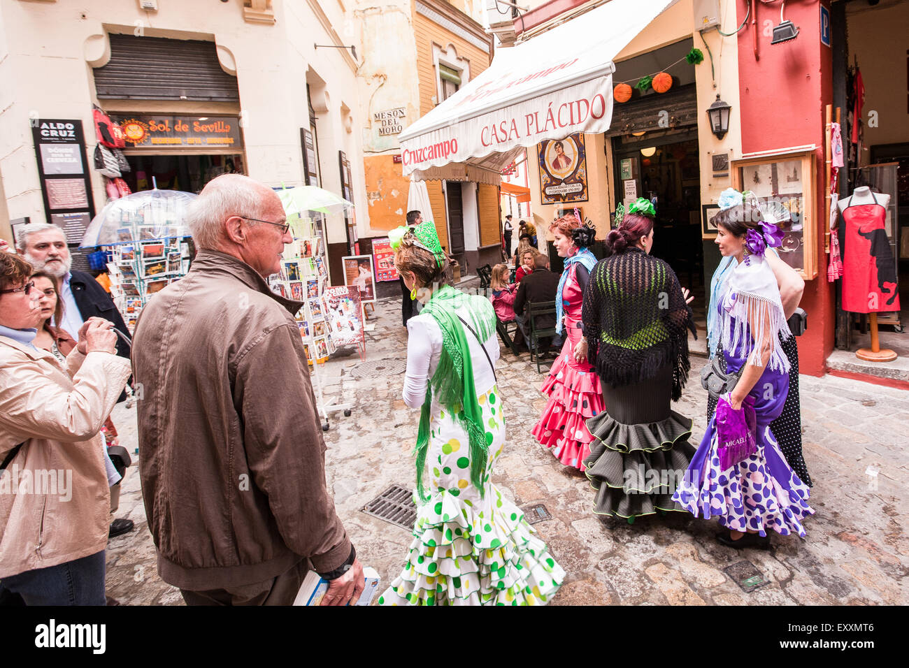Tourists and locals in traditional Seville dress in Santa Cruz, Old ...